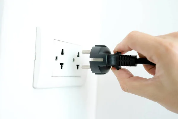 Hand of Electrical Appliances He was pulling the plug. Out of the plug ...