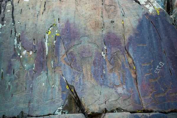 Drawn figures on the stone wall. Rock painting in mountain of Altai ...