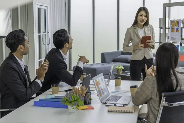 Asian woman department manager discussing duties new male employee on ...