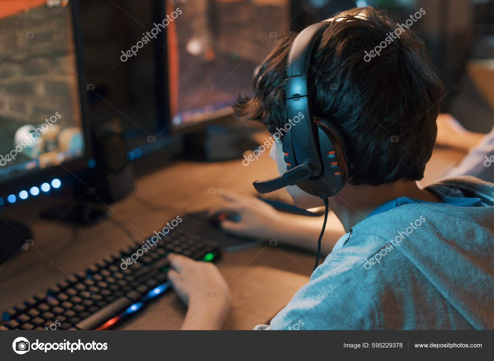 Young Gamer Wearing Headset Playing Online Multiplayer Video Games His ...