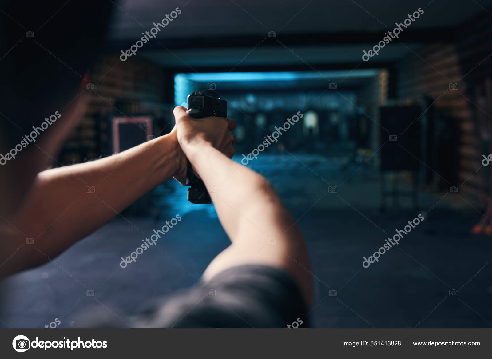 Female shooter mastering a two-handed hold during the shooting drill ...