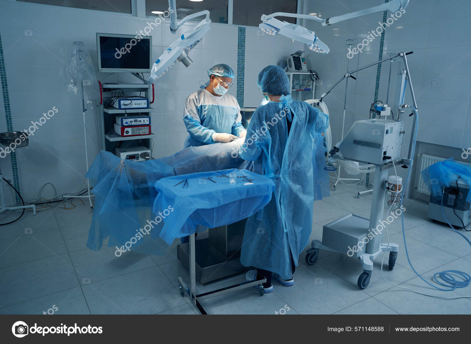 Two surgery experts conducting laparoscopic operation on patient — Stock Photo © svitlanahulko85 ...