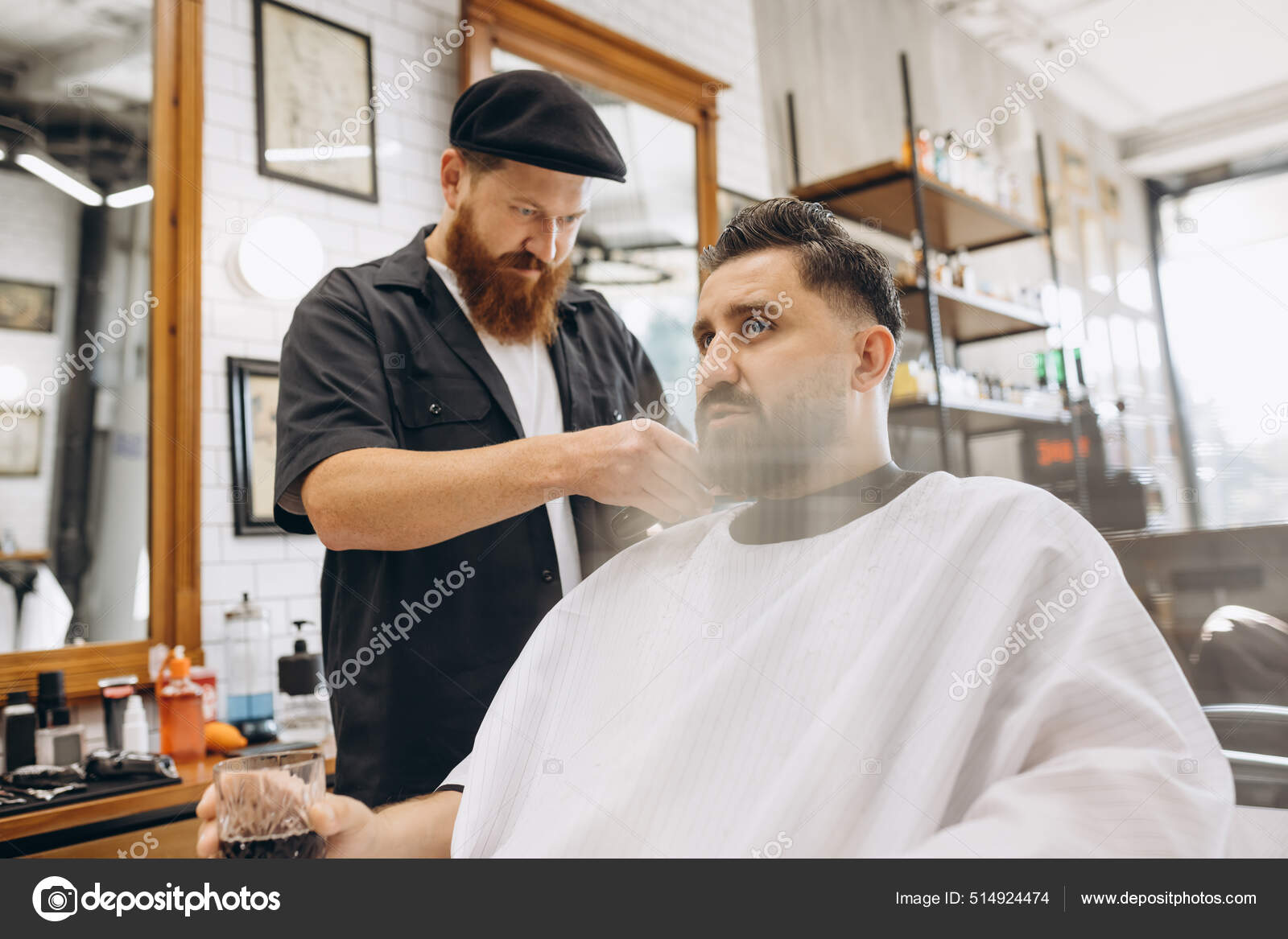 Two handsome men at barbershop. Stylish red-bearded barber and client ...