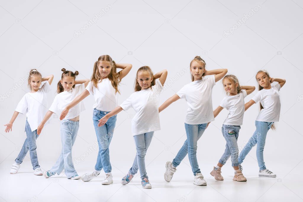 Modern choreography, synchronized movements. Active little girls ...