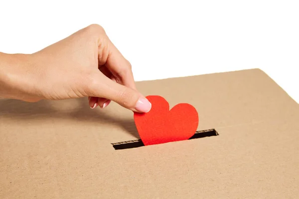 Charity. Red heart as symbol of peace, love is putting by female hand ...