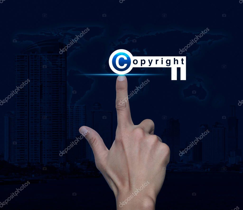 Hand pressing copyright key icon over world map, modern city tower and ...