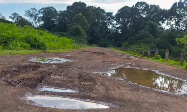 Rural damaged road with muds and holes - Stock Image - Everypixel