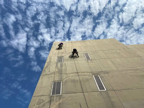 painter fixing the wall and painting on the wall of the building ...