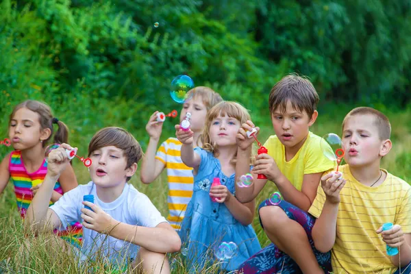 Children blowing bubbles Stock Photos, Royalty Free Children blowing ...