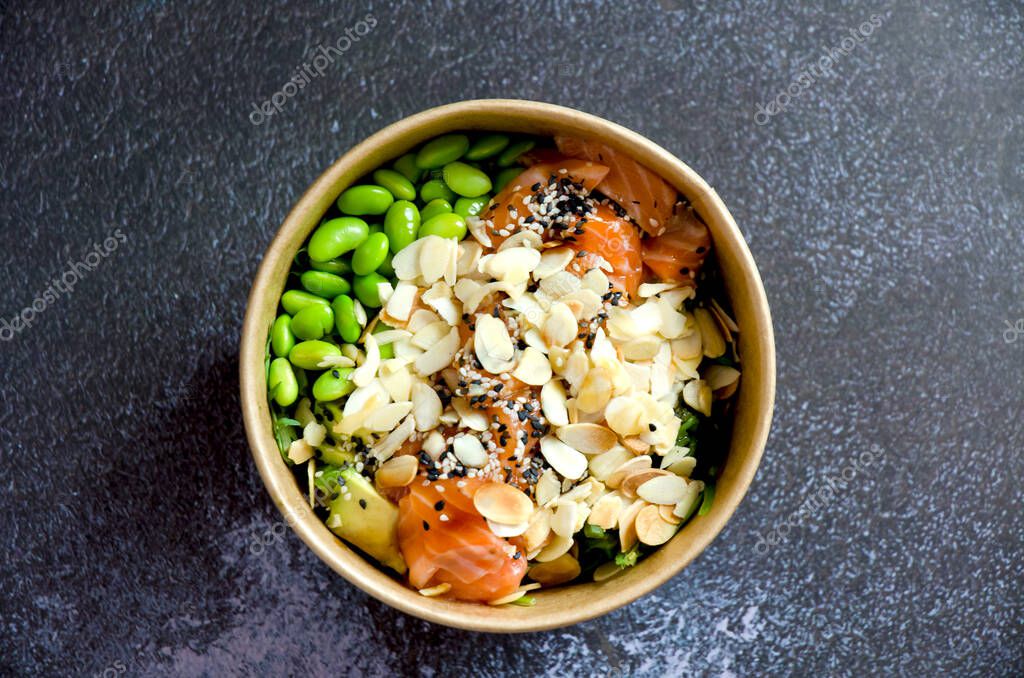 Top view of wok box, bowl of rice on black background. Rice fried and ...