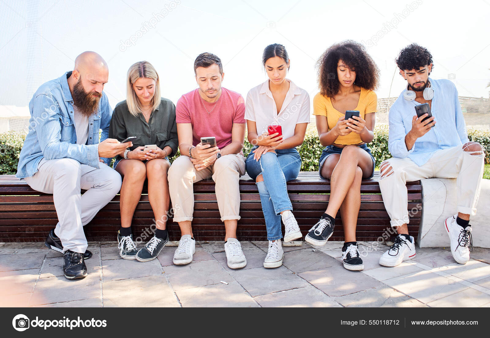 Group of serious people addicted technology. Friends using phone ...
