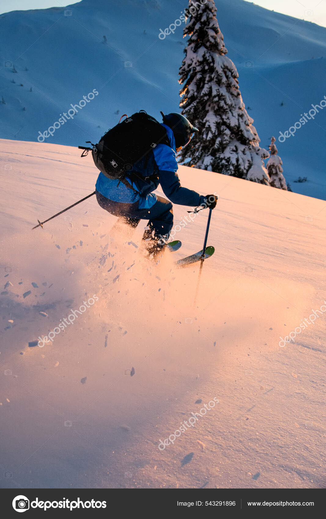 Man freerider sliding down snow-covered slopes on fresh powder snow ...