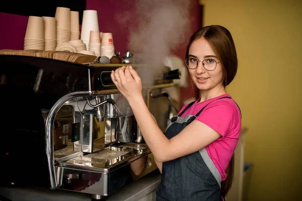 great view on beautiful young woman barista who stands at modern coffee ...