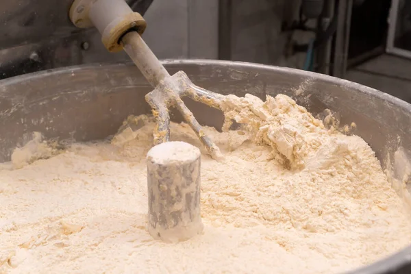 Close-up of the process of kneading mixing bread dough in a kneading ...