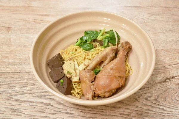 boiled dry egg yellow noodles topping braised chicken leg and foot ...