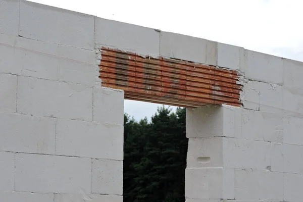 A reinforced brick lintel, a rough window opening and walls made of ...