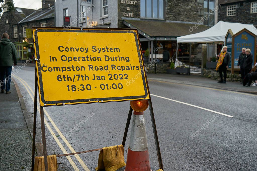 Yellow sign with black text with information about a traffic convoy ...