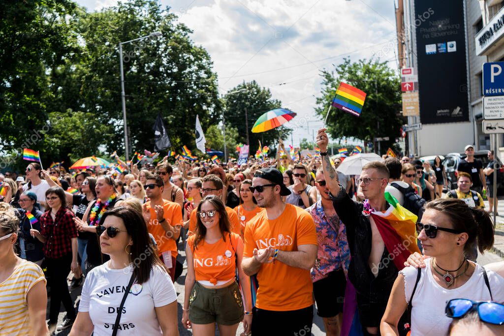 People marching for equal rights for LGBTQ+ community with rainbow ...