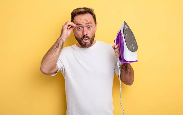 middle age man looking surprised, realizing a new thought, idea or ...