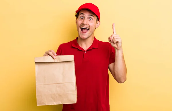 young handsome guy feeling like a happy and excited genius after ...