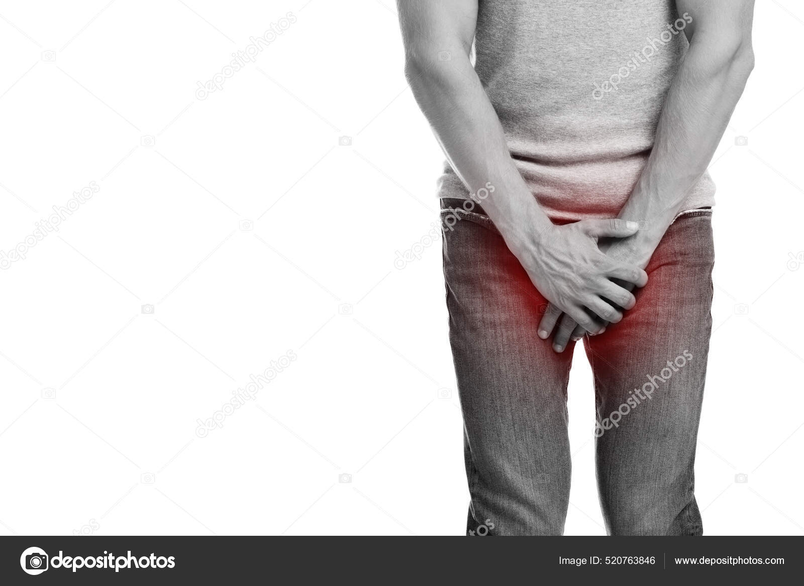 Millennial caucasian man suffering from groin pain, presses his hand to ...