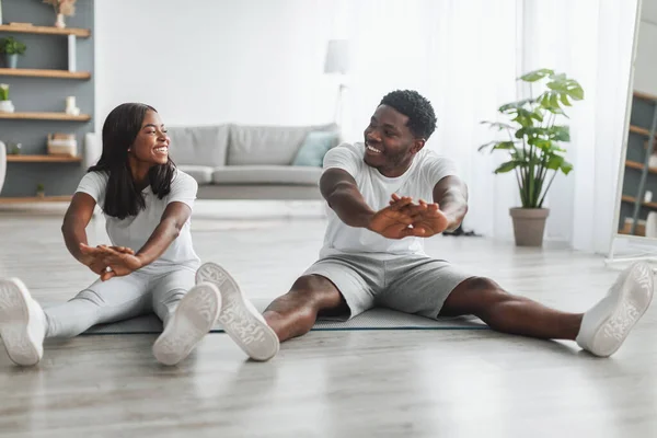 Young black couple planking together in living room Stock Photo by ...