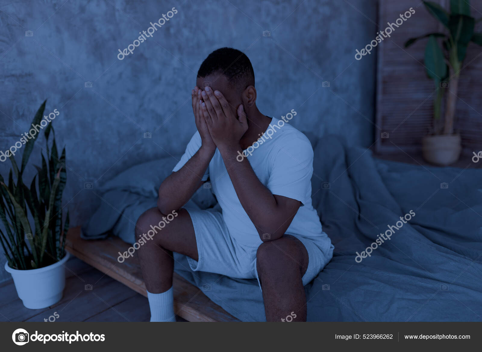Black man suffering from insomnia sitting on bed — Stock Photo © Milkos ...