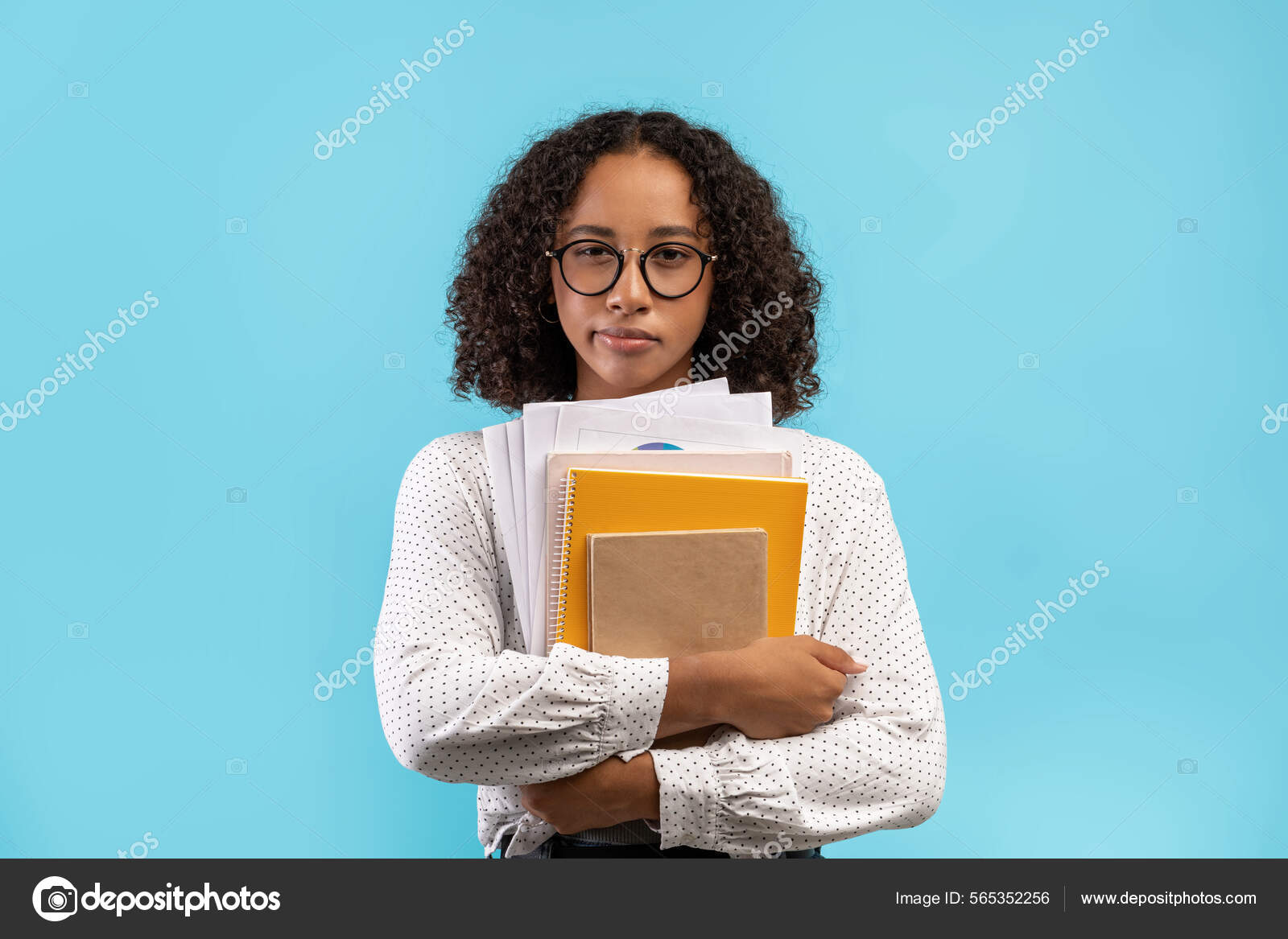 Doubtful young black female student with notebooks and papers looking ...