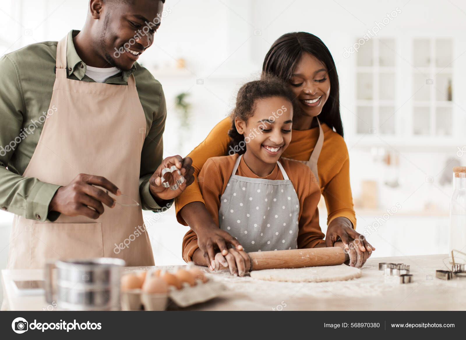 African Family Making Cookies Rolling Out Dough Baking In Kitchen ...