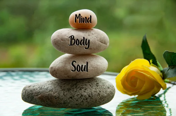 Mind, Body and Soul words engraved on zen stones with blurred nature ...