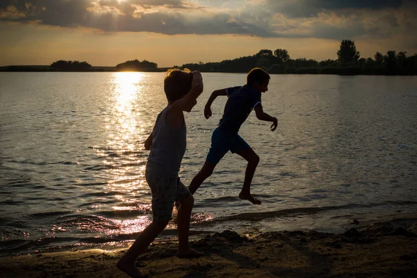 Kids playing sunset Stock Photos, Royalty Free Kids playing sunset ...