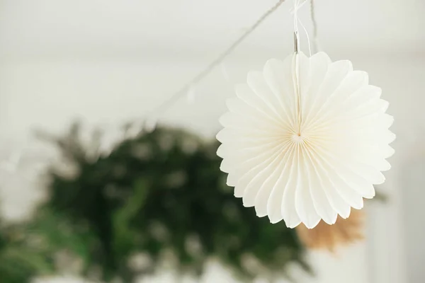 Stylish paper christmas stars hanging on background of festive ...