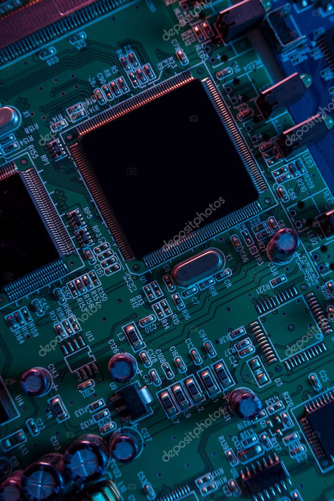 Microcircuit with chip close up with neon lighting. Chip shortage 2023