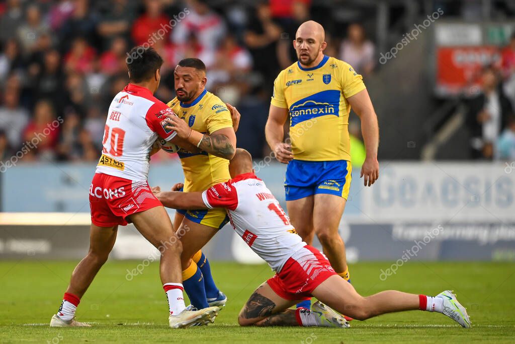 Elliot Minchella #17 of Hull KR is tackled by James Bell #20 and Jake ...