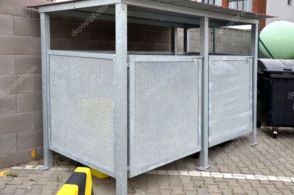yard for placing containers for sorting household waste. gray door and ...