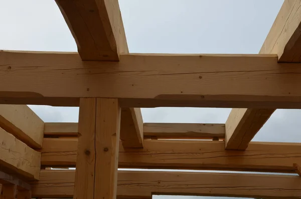 a carpenter built a log cabin with rough hewn beams. wood planing was ...