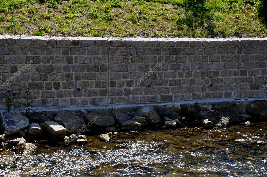 restoration of the retaining wall directly above the mountain stream ...