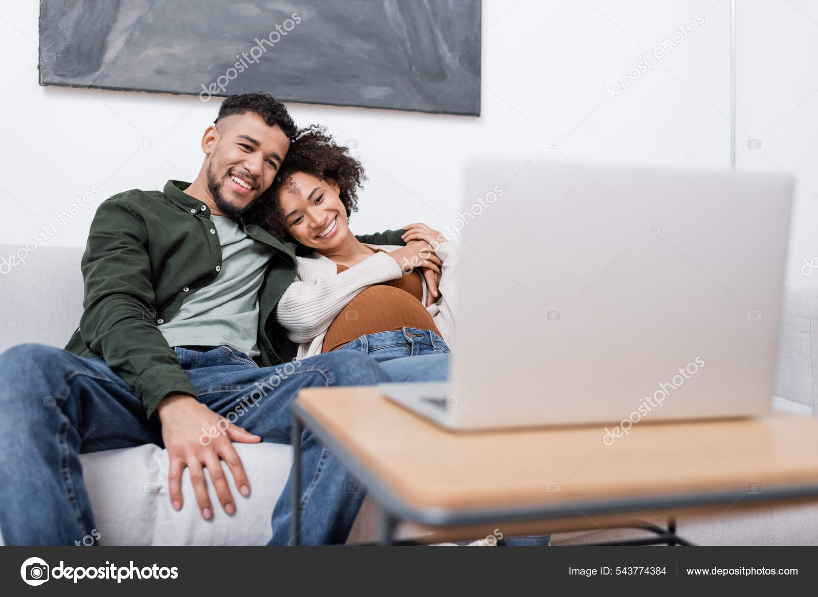 Pleased African American Man Hugging Pregnant Wife While Watching Movie