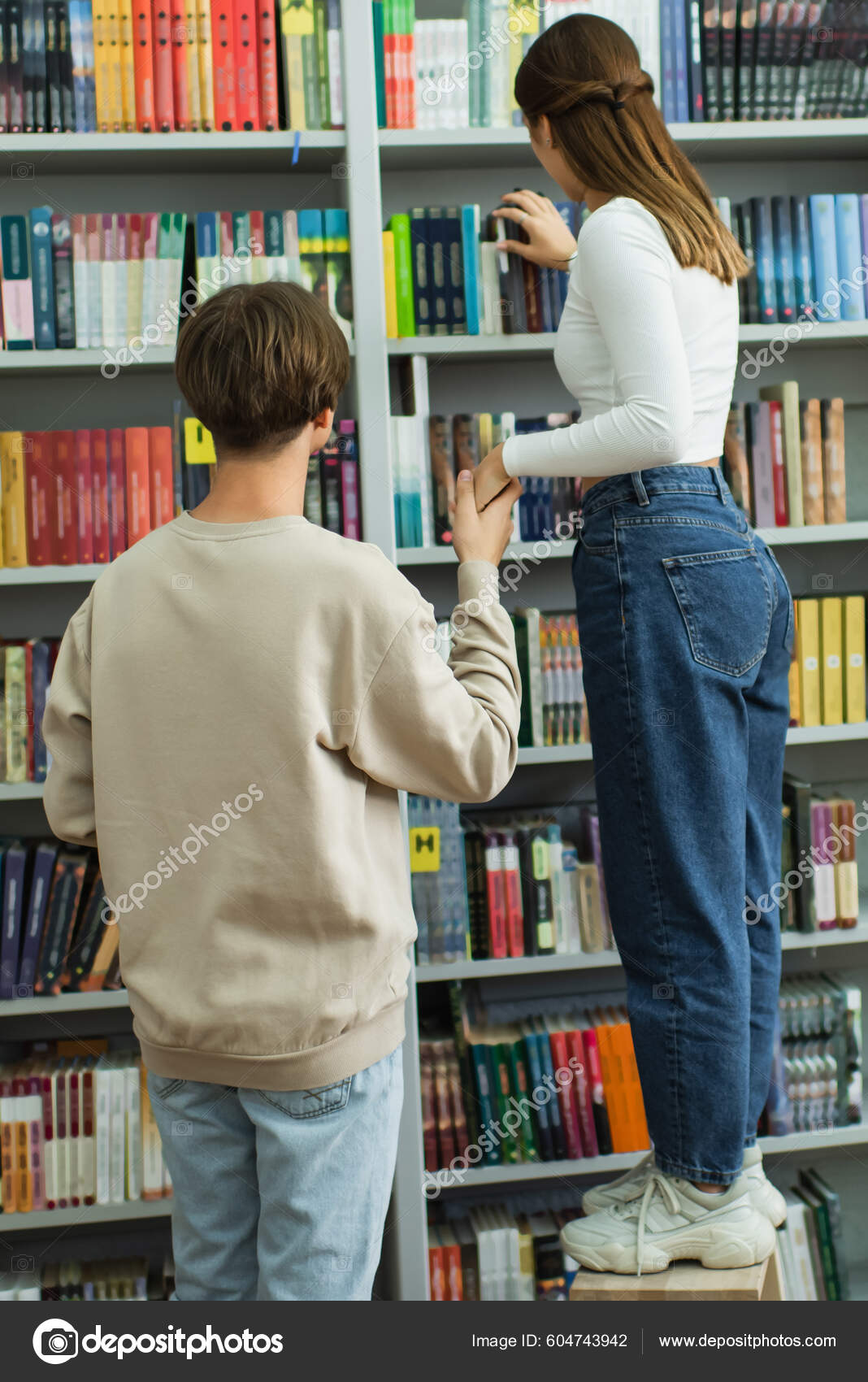 Back View Student Holding Hand Teenage Girl Choosing Books Shelves ...