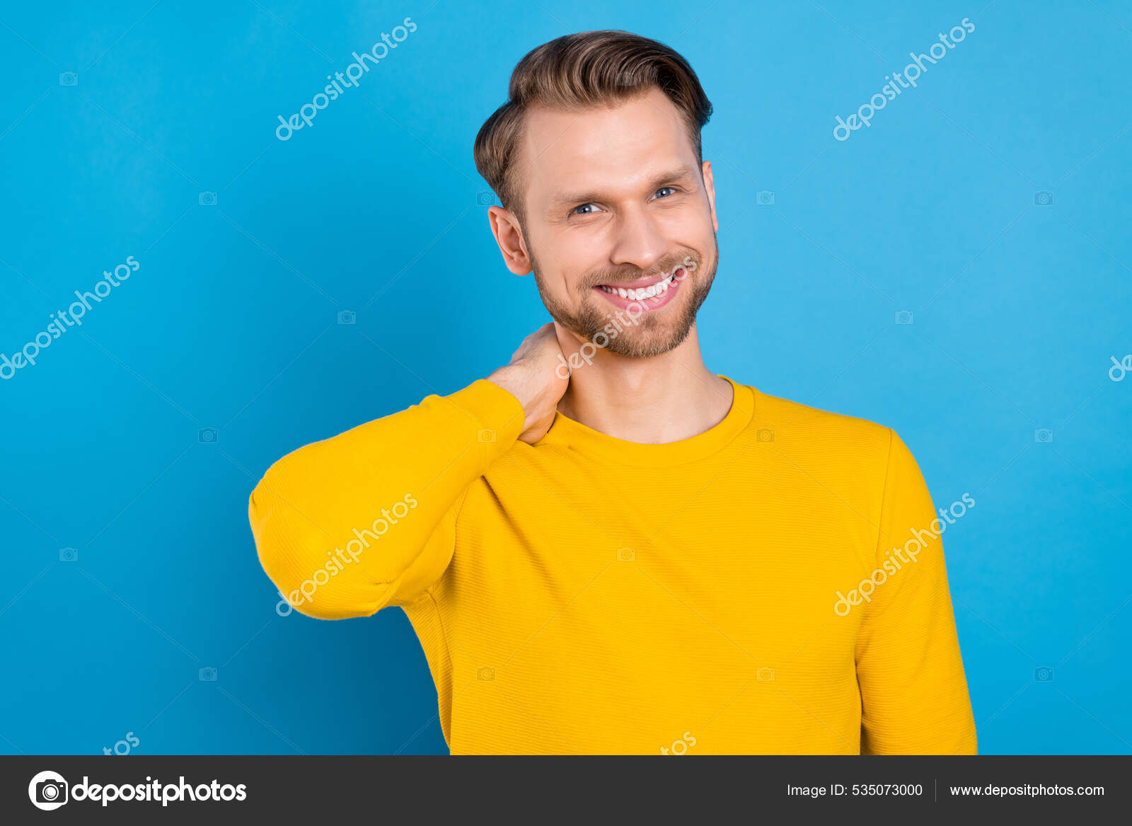 Photo of young handsome guy happy positive smile hand touch neck ...