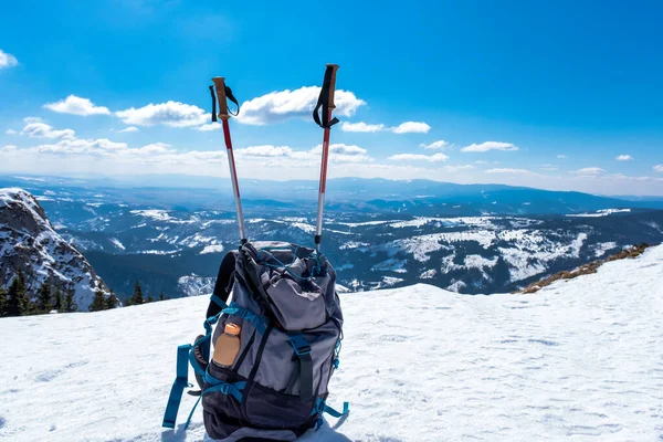 Backpack and Trekking Pole on top of the winter mountains - Stock Image ...