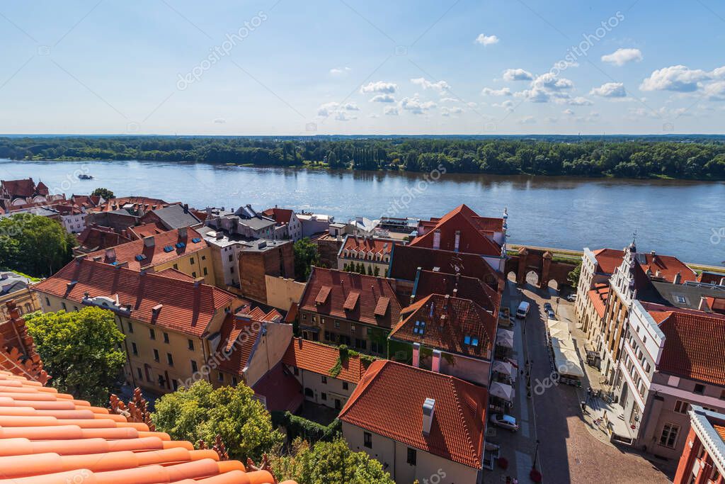 view of the old town of Torun and the Vistula river from above during a ...