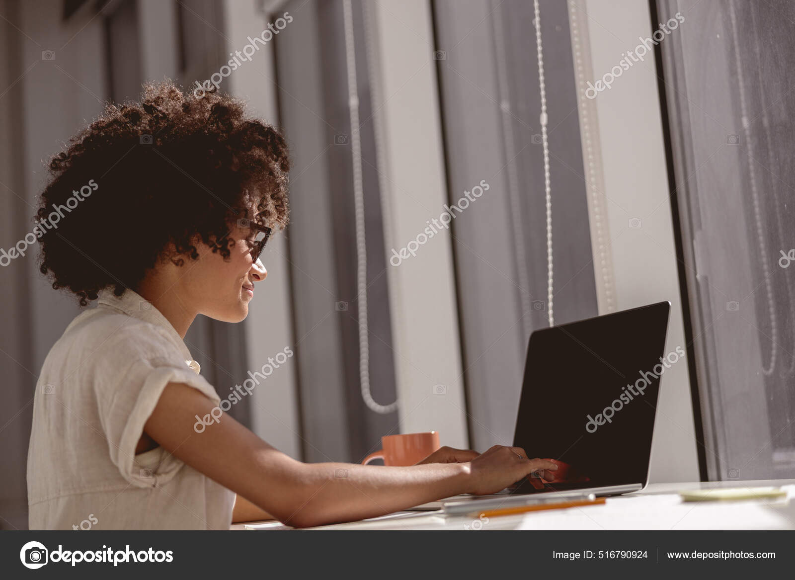 Pretty young woman busy while using her laptop Stock Photo by ...