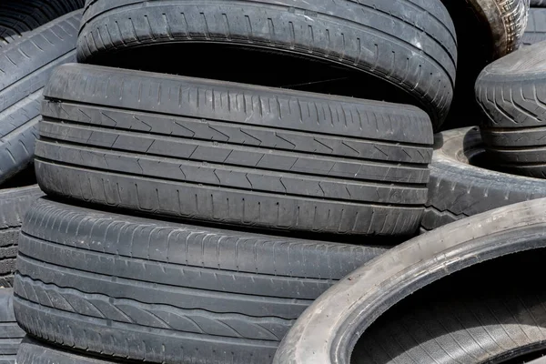 Old car tires, worn-out car tire tread, a dump of used tires from used ...