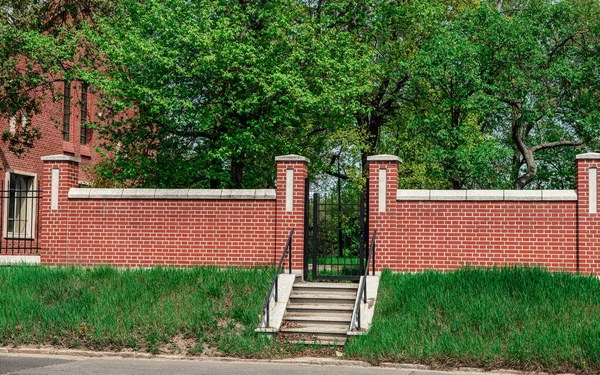 Brick fence and entrance to the yard. Red brick fence. Entrance. Gate ...
