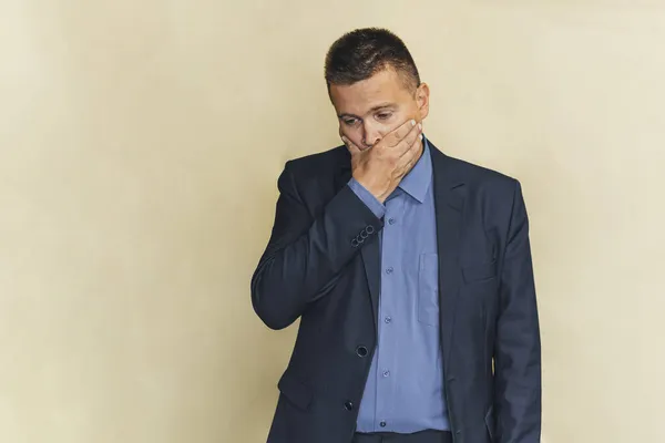 Confusion, Men, Business. a man holds his mouth with his hands an ...