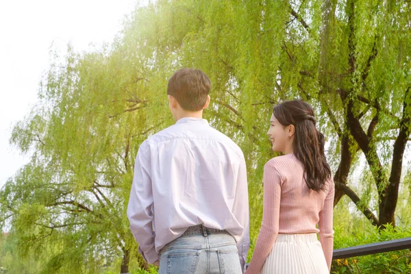 Korean Asian couple enjoying spring date_hugging - Stock Image - Everypixel