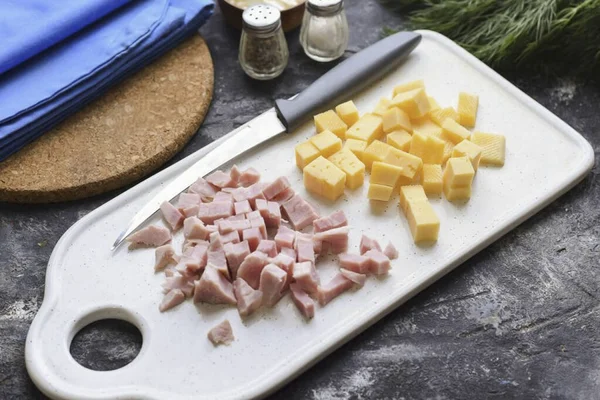 Cut ham and hard cheese into small cubes. 2024