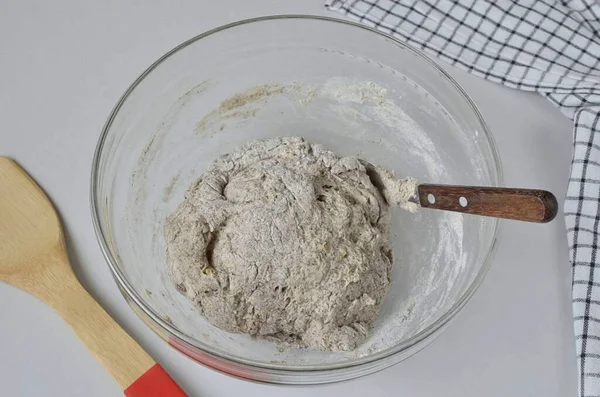 When the flour is all moistened, collect the dough in a lump. Dust the ...