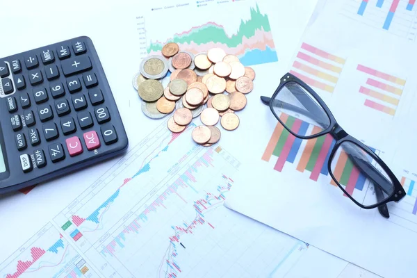 flat lay a glasses, money, calculator and chart or graph on office desk ...